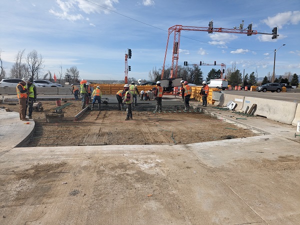Crews working on concrete formwork and rebar at the intersection of CO ...